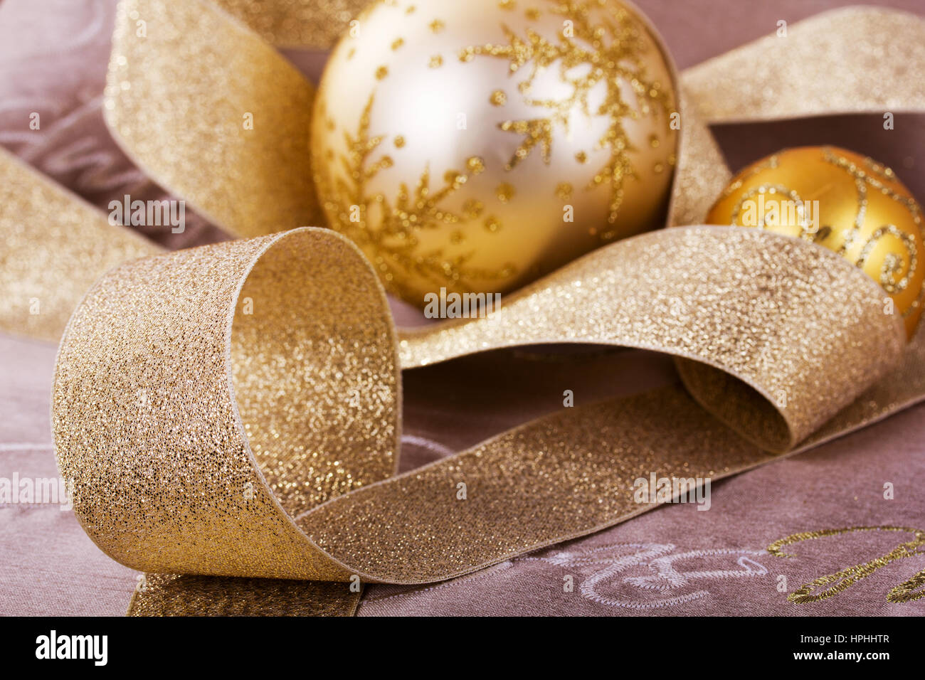 Festive gold Christmas decorations on a fabric background Stock Photo ...
