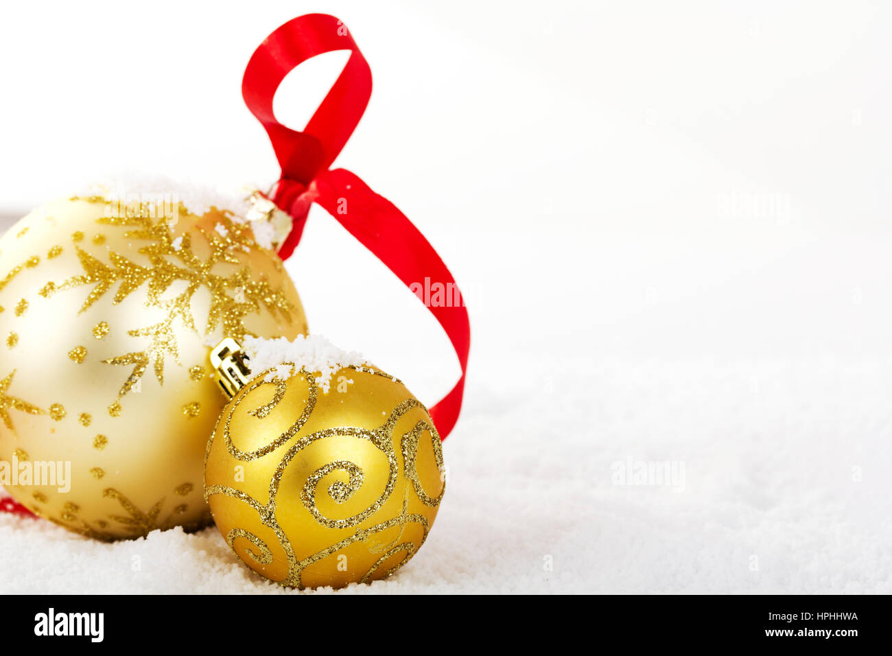 Gold Christmas decorations in white snow for a background Stock Photo ...
