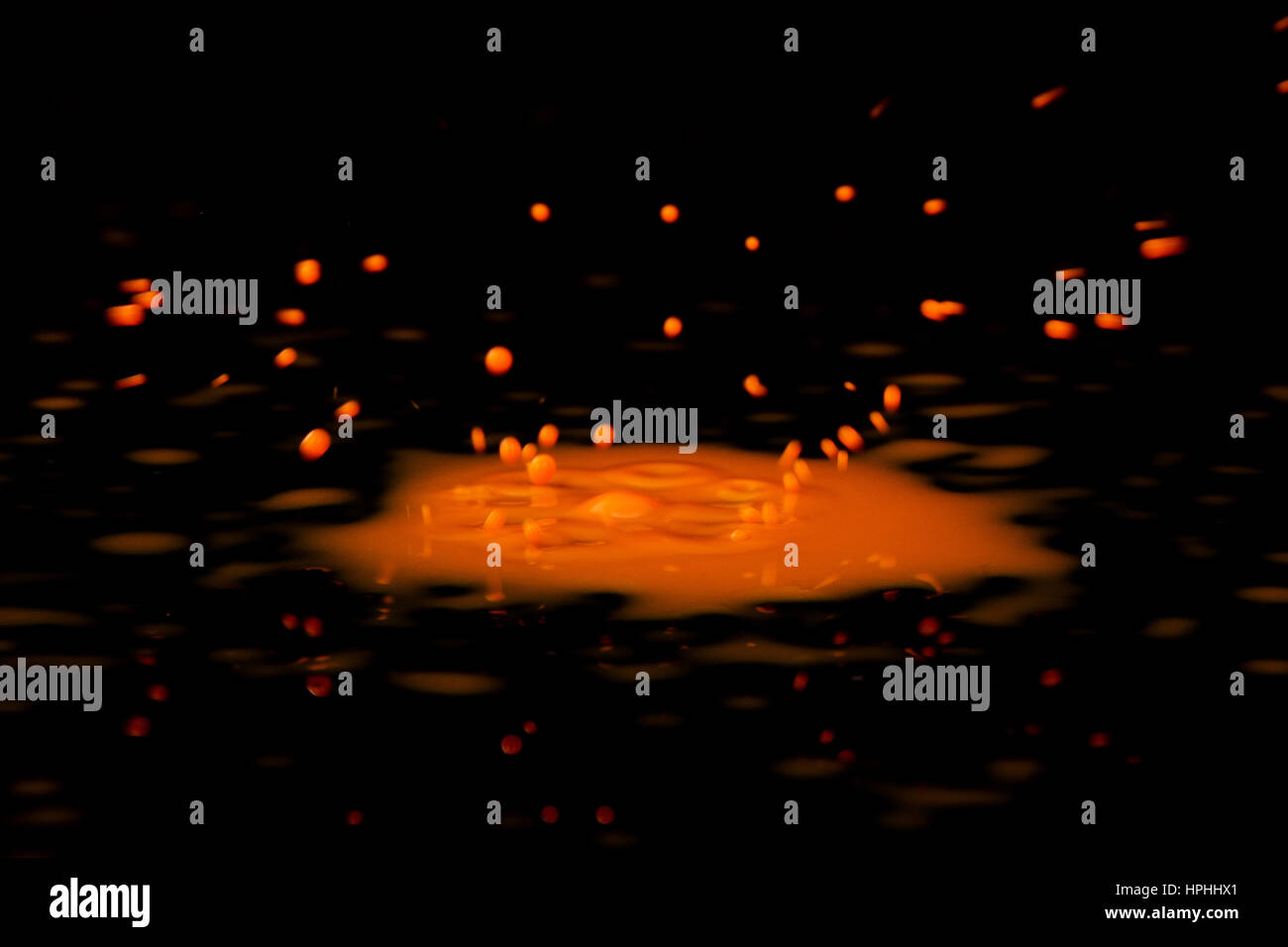 Colorful paint drop splashing on black a background Stock Photo - Alamy