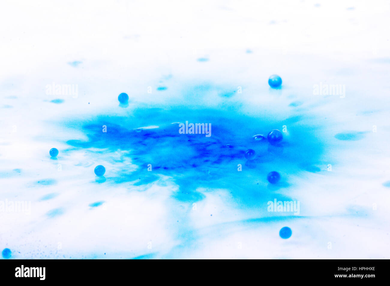 Colorful paint drop splashing on black a background Stock Photo - Alamy