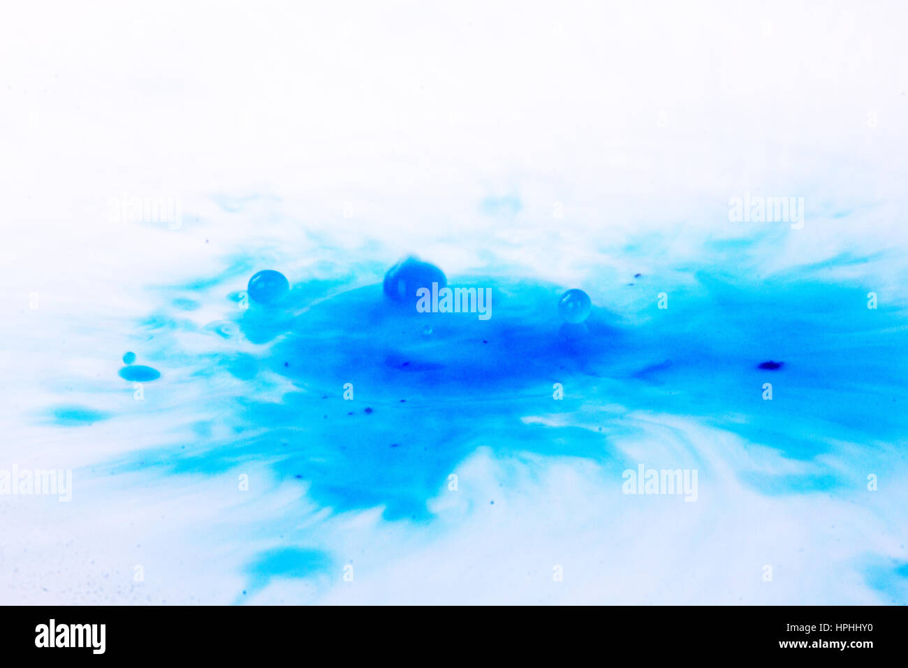 Colorful paint drop splashing on black a background Stock Photo - Alamy