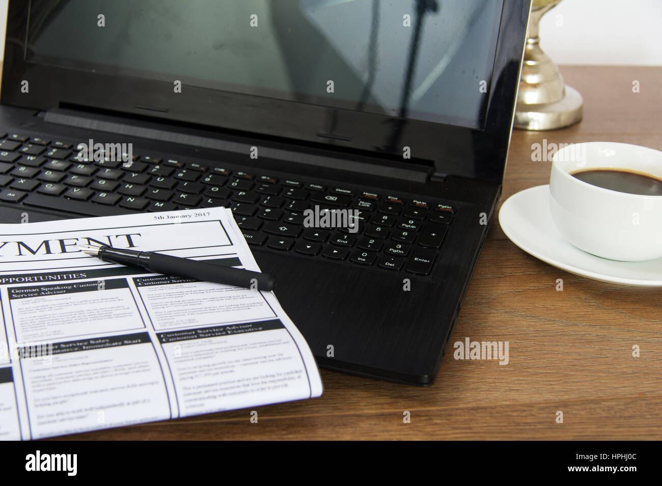 Searching for a new job or employment in a newspaper Stock Photo - Alamy