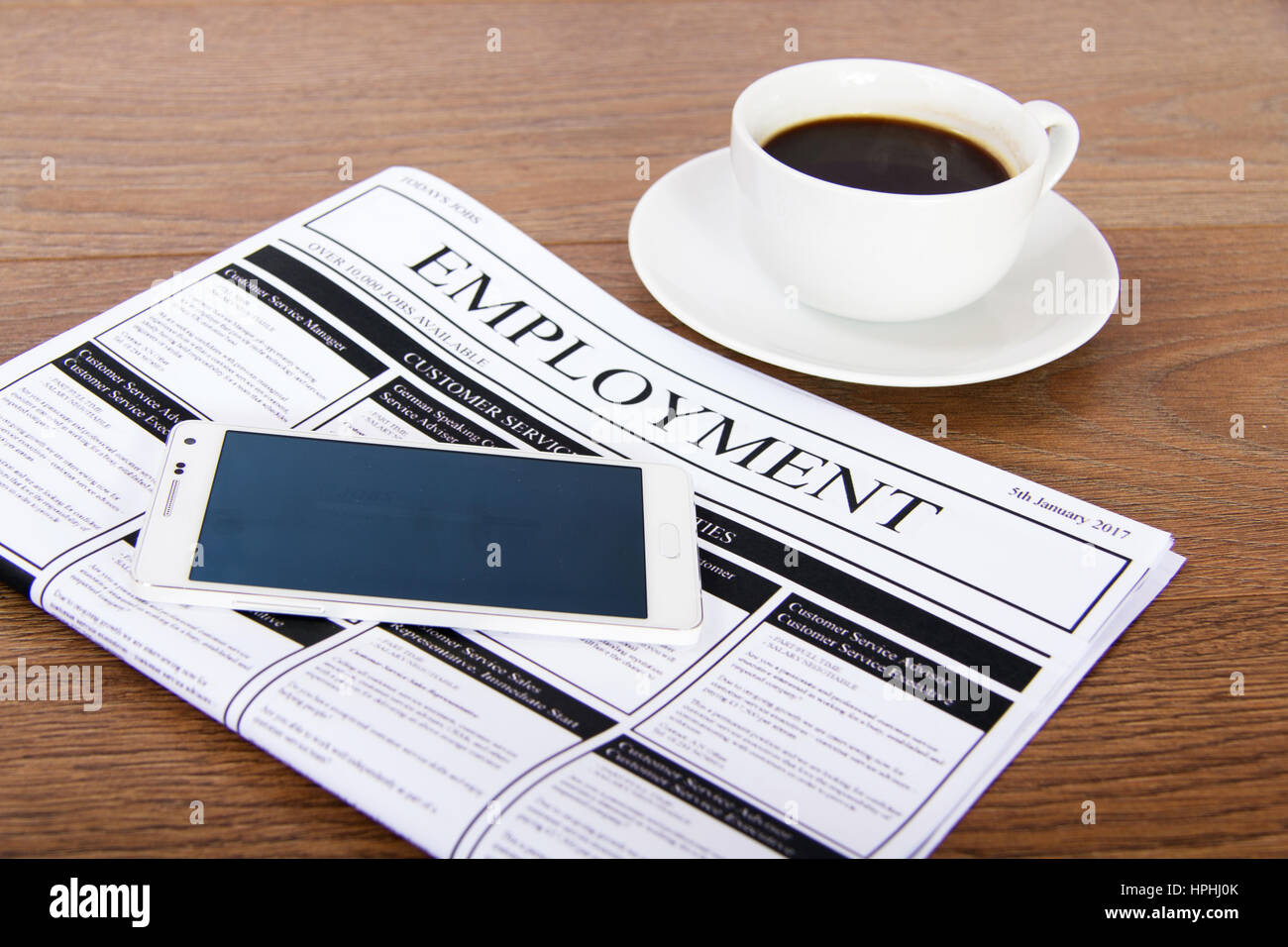 Searching for a new job or employment in a newspaper Stock Photo - Alamy