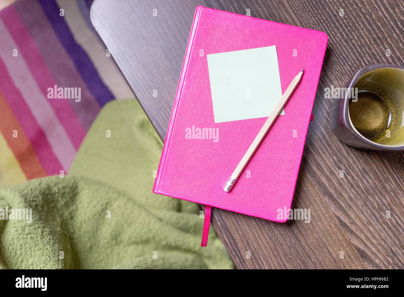 Pink notebook, pen and cup Stock Photo - Alamy