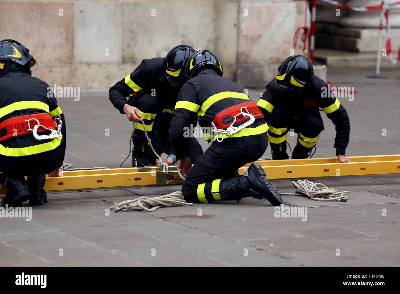 firefighters mounting the ladder to reach the upper floors of the ...