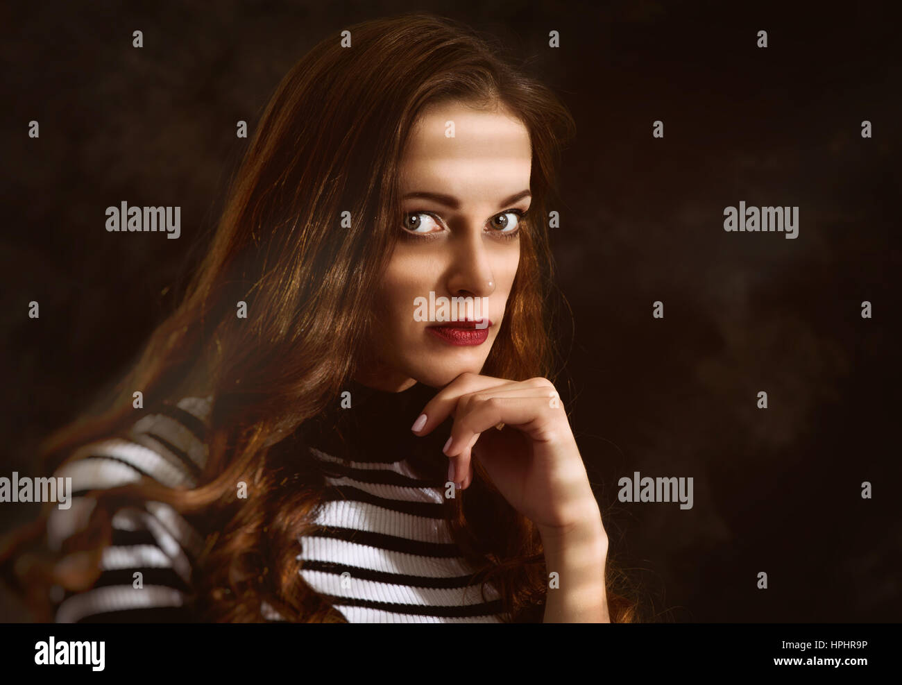 Serious sad woman thinking over a problem. Dark background Stock Photo ...