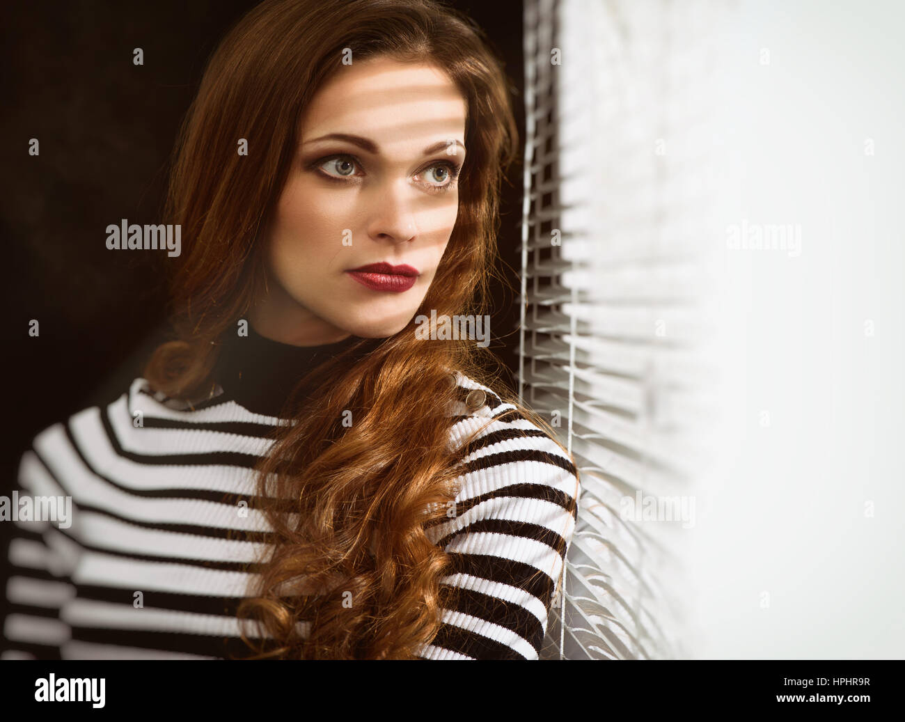 Portrait of sad woman looking out the window Stock Photo - Alamy