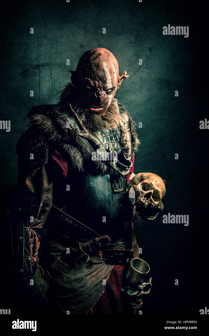 Orc holding a skull Stock Photo - Alamy