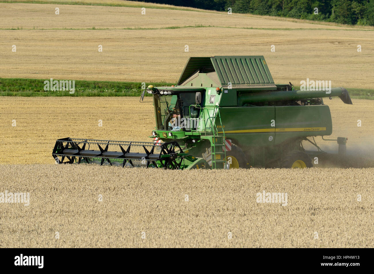 Combine, harvesting wheat Stock Photo - Alamy