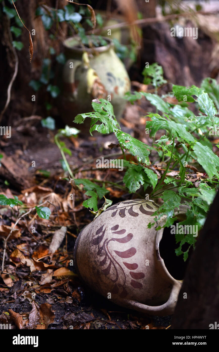 Damaged and cracked old handmade pottery vessels abandoned in the ...