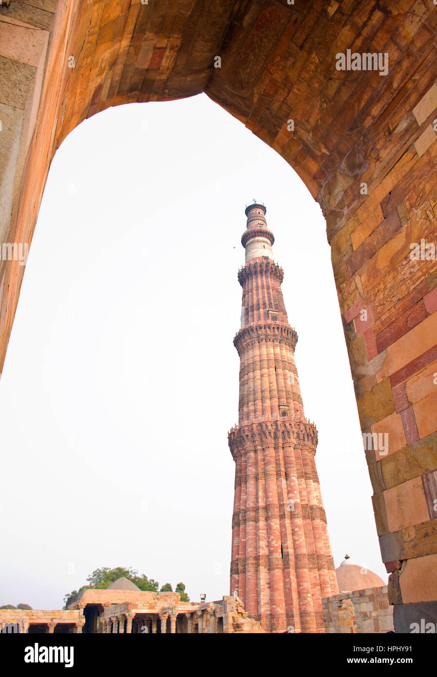 The Qutub Minar minaret, viewed through an arch, in the Qutb Minar ...