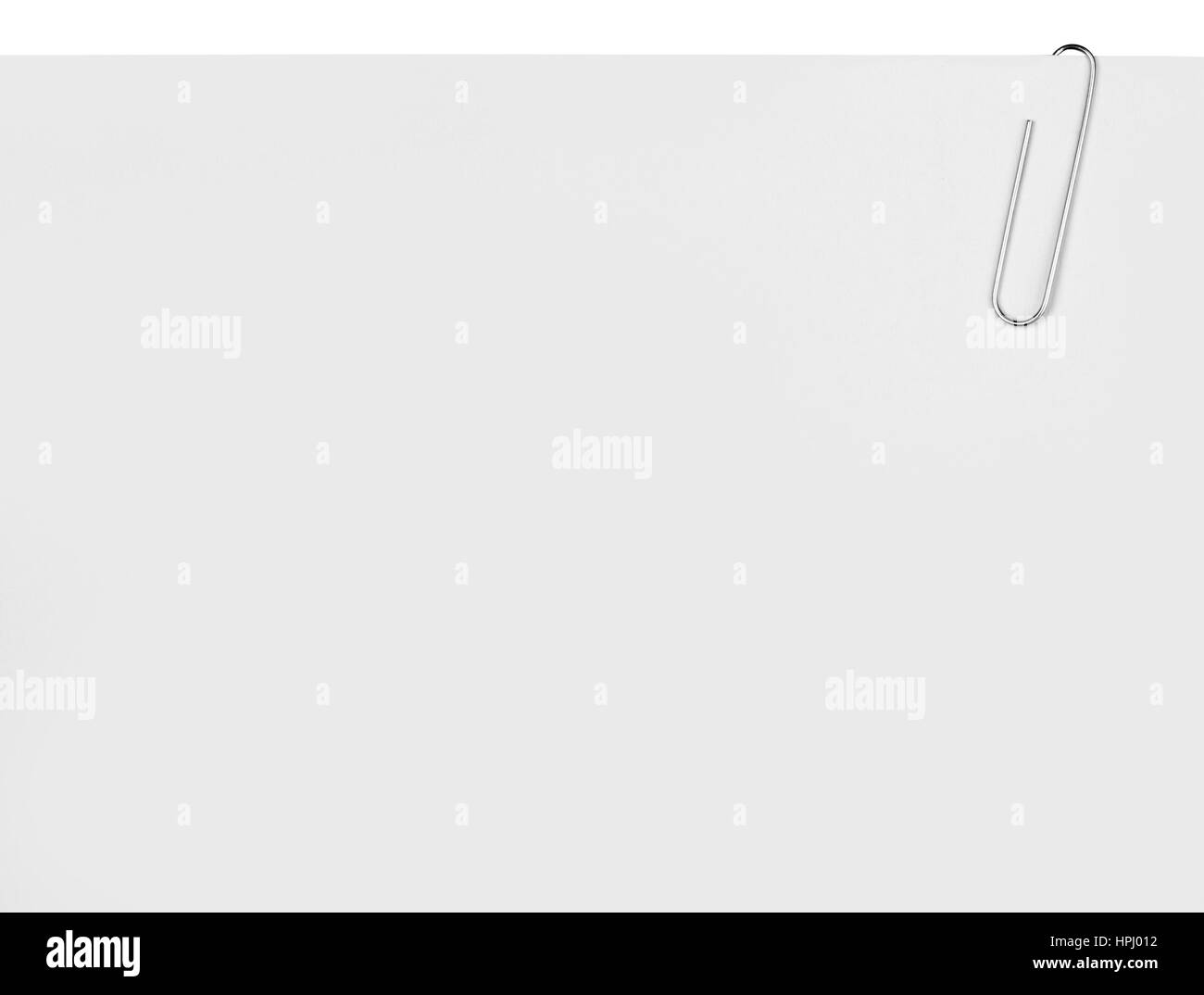 Close up of paper clip holding a blank paper sheet Stock Photo - Alamy