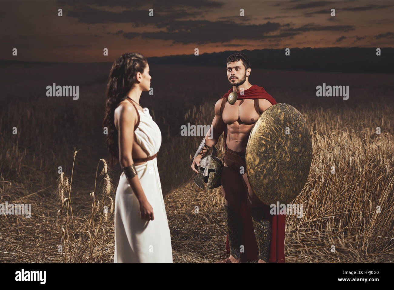 Side view of woman wearing like greece in white dress and man warrior ...