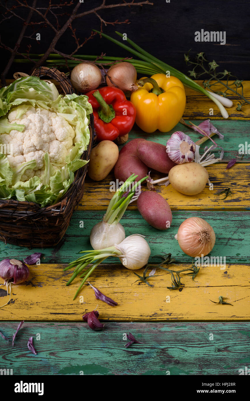 Healthy food background. Garden vegetables over colorful wooden table ...