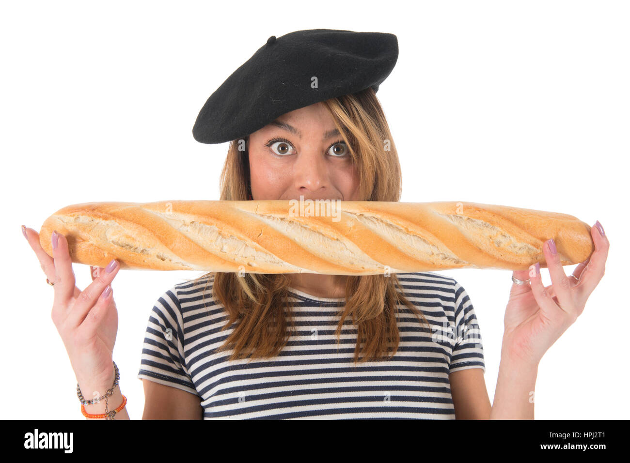 Young French girl with typical French barret and striped shirt eating ...