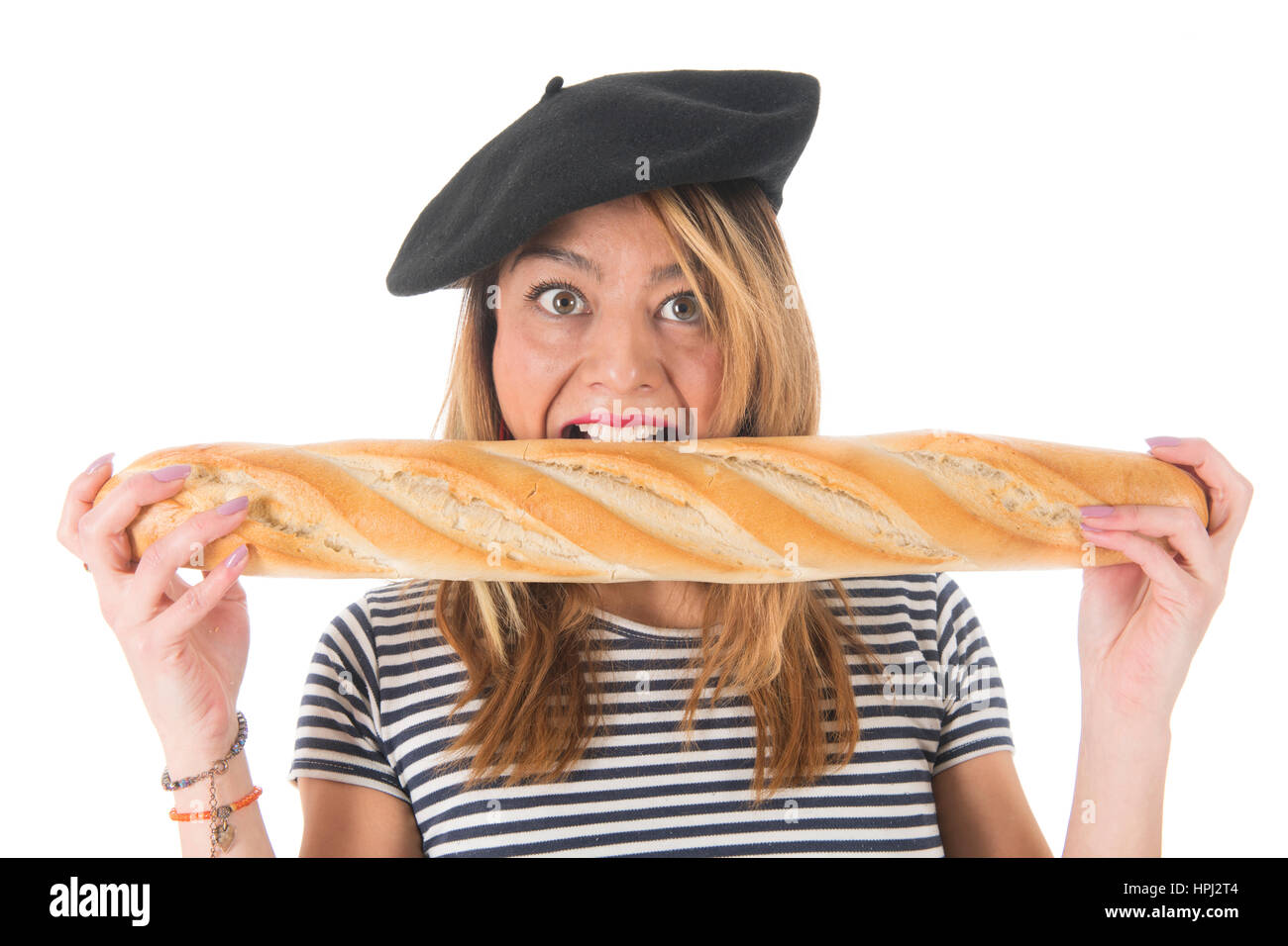 Young French girl with typical French barret and striped shirt eating ...