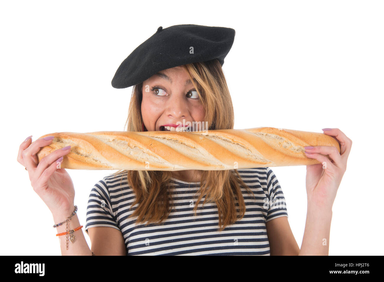 Young French girl with typical French barret and striped shirt eating ...
