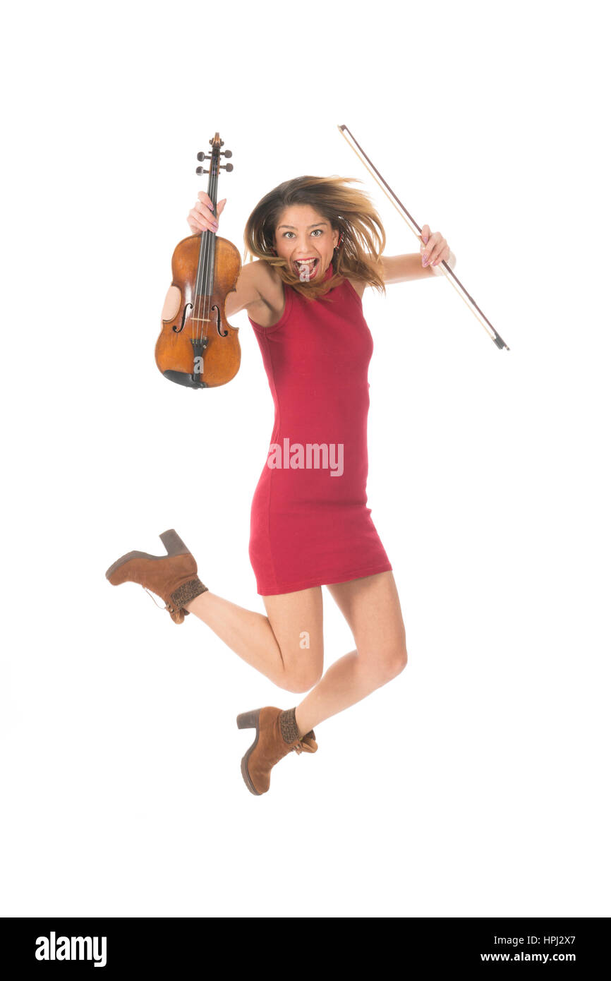 Young woman jumping high with violin music instrument isolated over ...