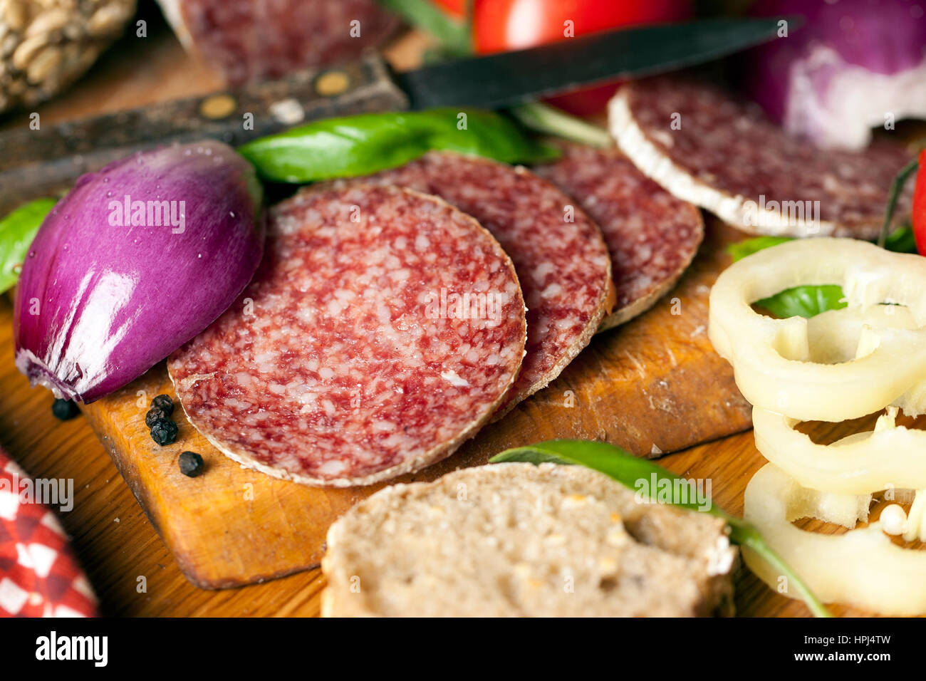 Salami on wooden desk Stock Photo - Alamy