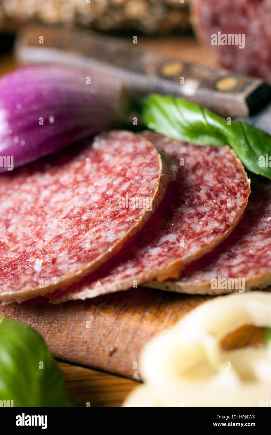 Salami on wooden desk Stock Photo - Alamy