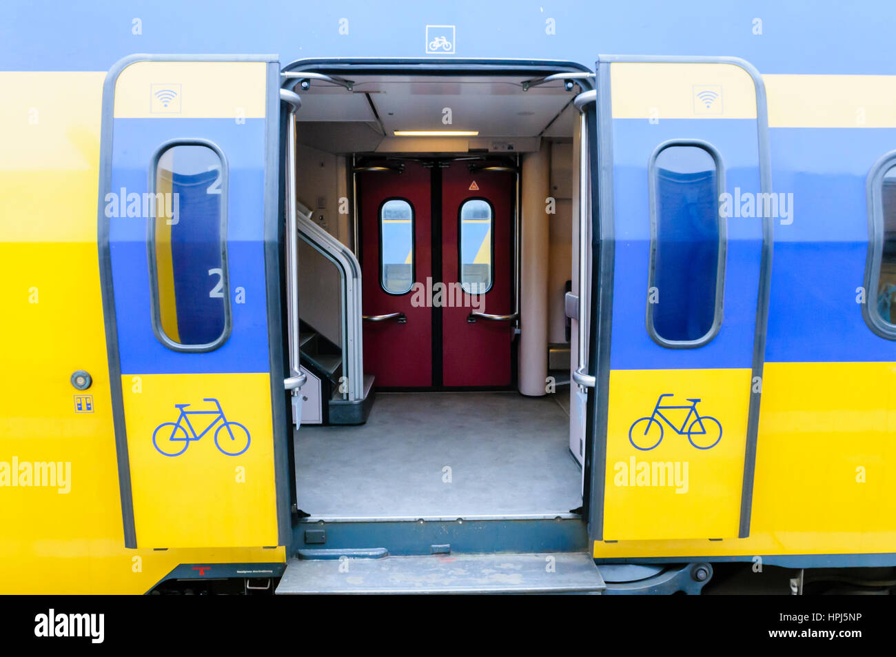 Nederlandse Spoorwegen yellow and blue train at a platform in the ...