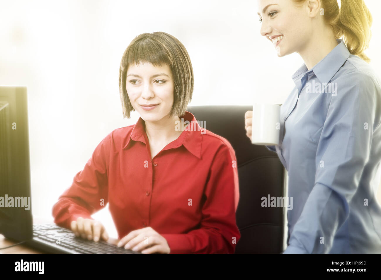 two work colleagues working together in the office Stock Photo - Alamy