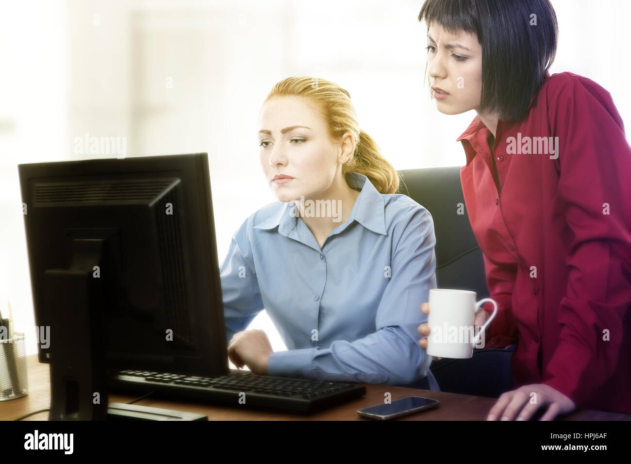 two work colleagues working together in the office Stock Photo - Alamy