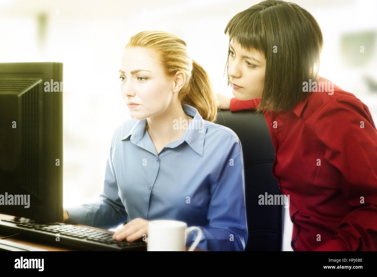 two work colleagues working together in the office Stock Photo - Alamy