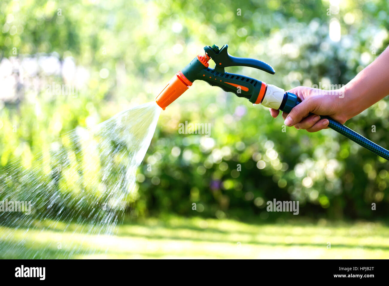 Man holding hose hi-res stock photography and images - Alamy