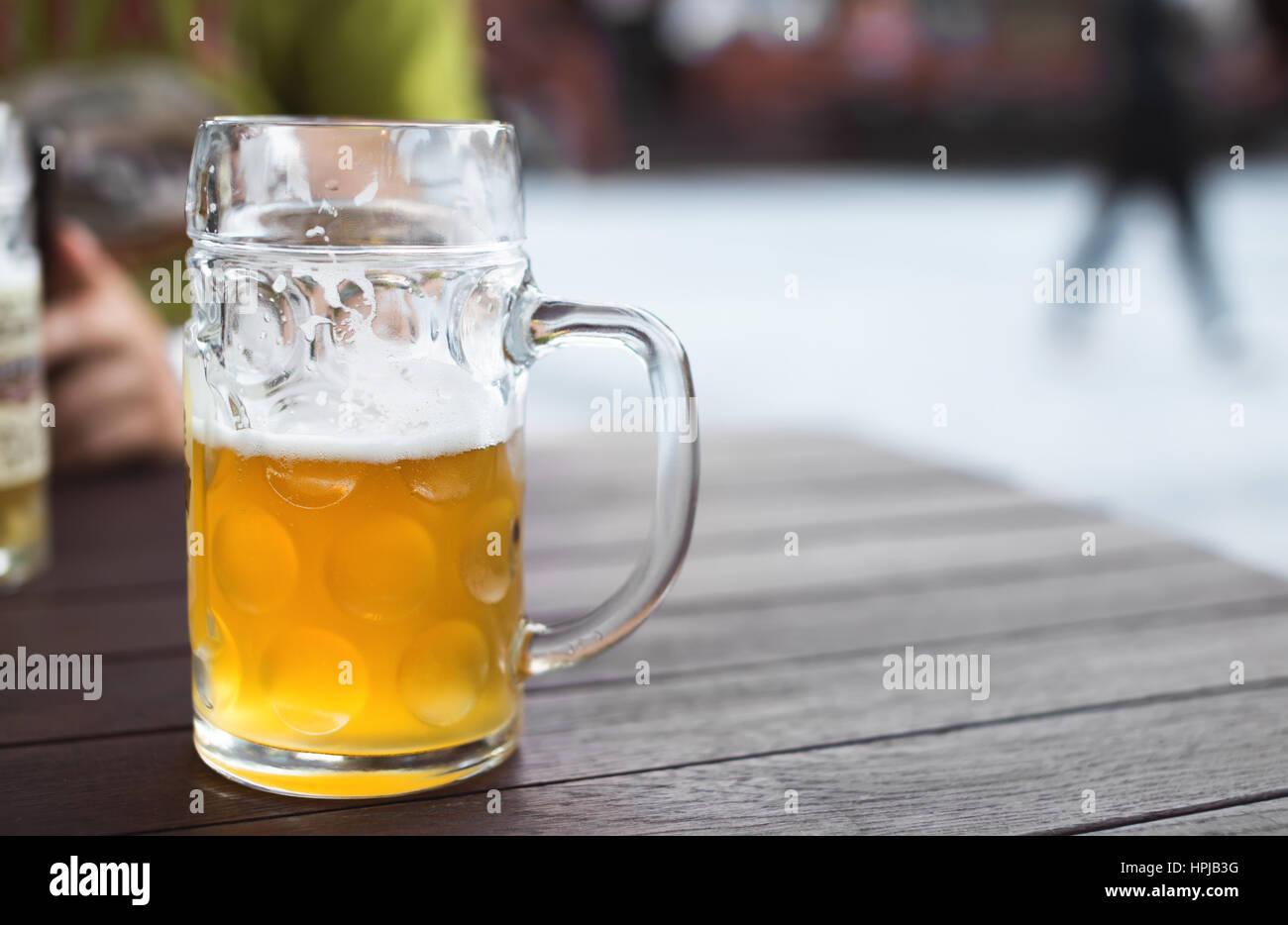Tapped craft lager beer glass on table in pub. Shallow depth of field ...
