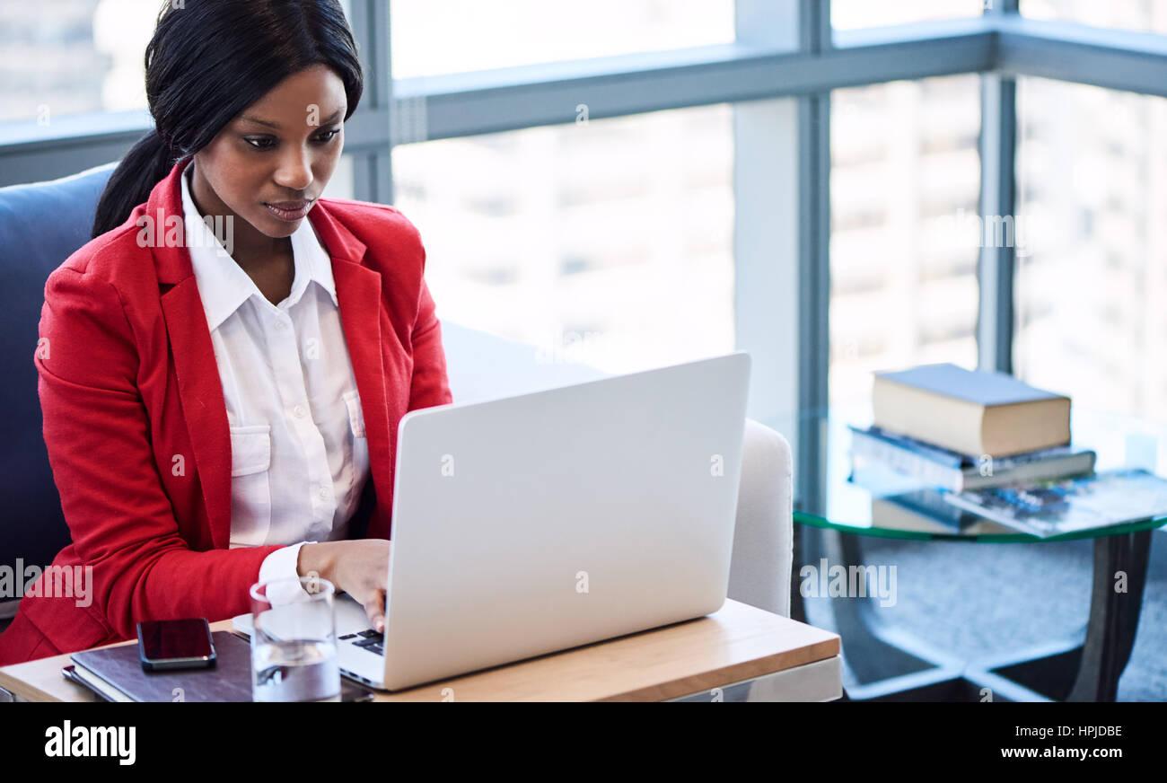 African American business woman busy looking at her computer screen ...