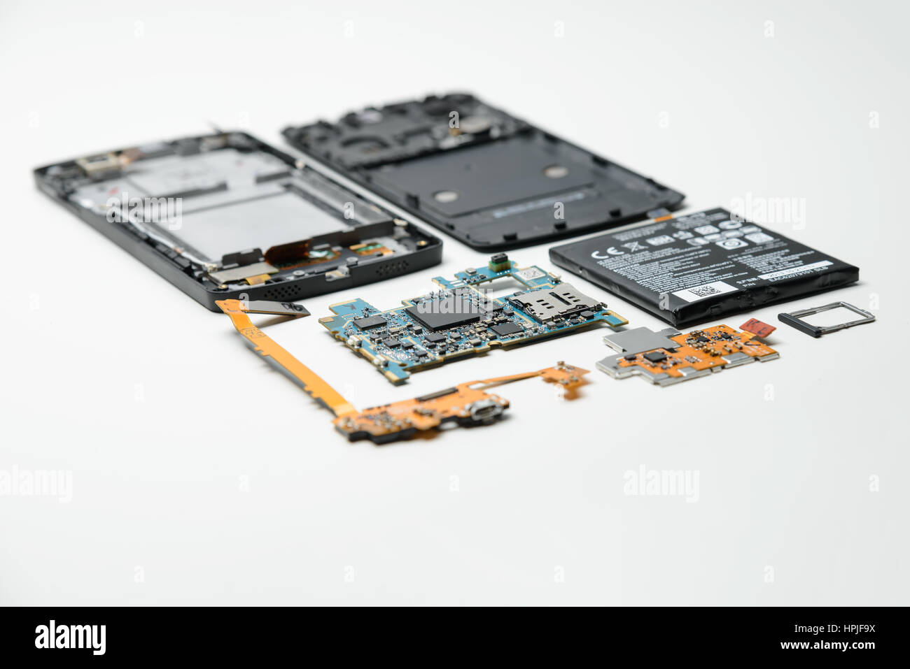Disassembled smartphone with different electronic parts and lithium ion ...