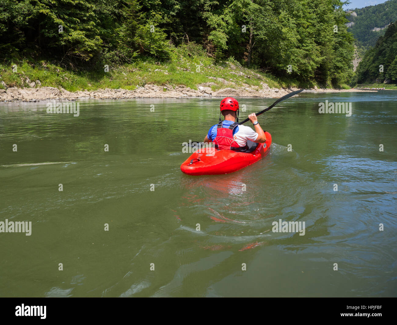 Adventurer man rafting with canoe Stock Photo - Alamy