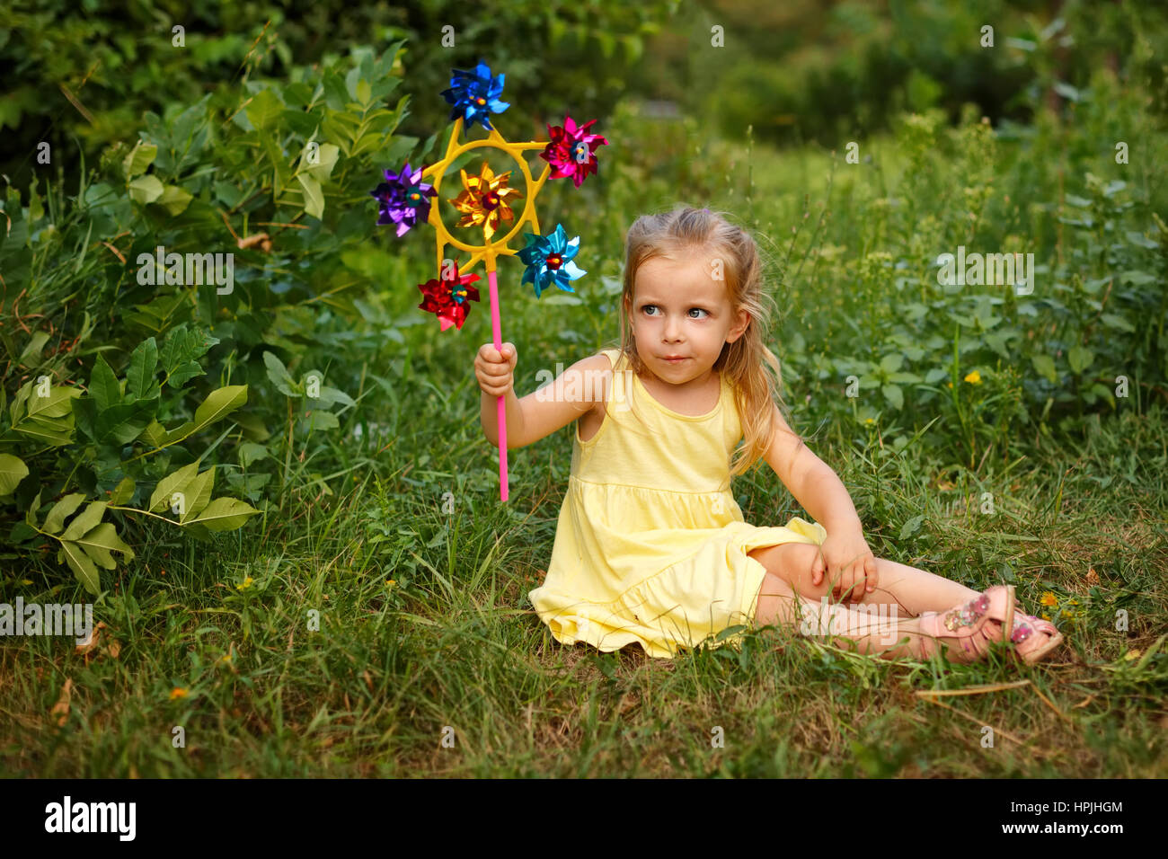 Girl with a pinwheel hi-res stock photography and images - Alamy