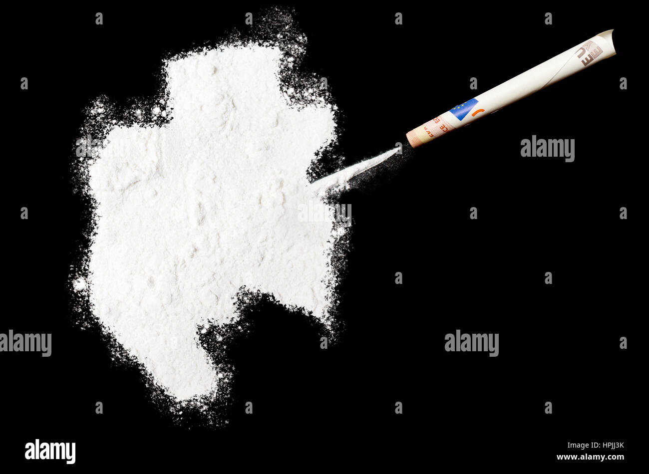 A powder drug like cocaine in the shape of Gabon with a rolled money ...