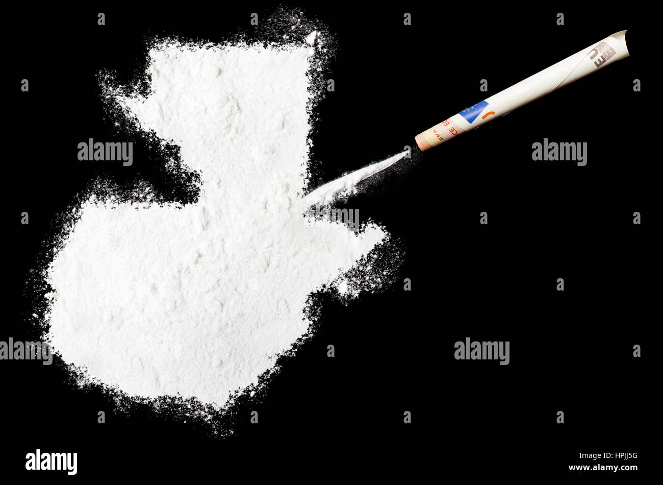 A powder drug like cocaine in the shape of Guatemala with a rolled ...