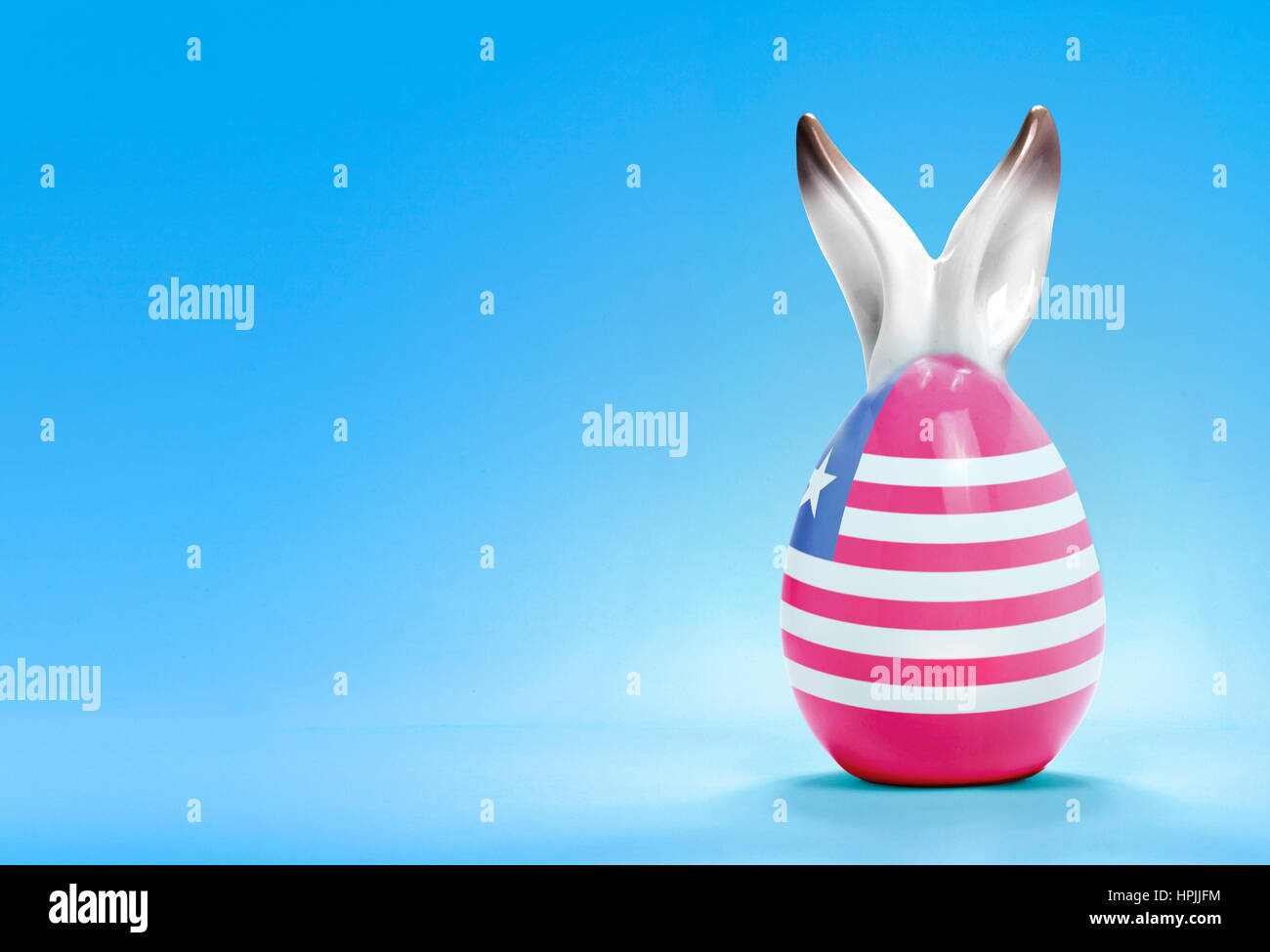 Colorful cute ceramic easter egg with rabbit ears and the flag of ...