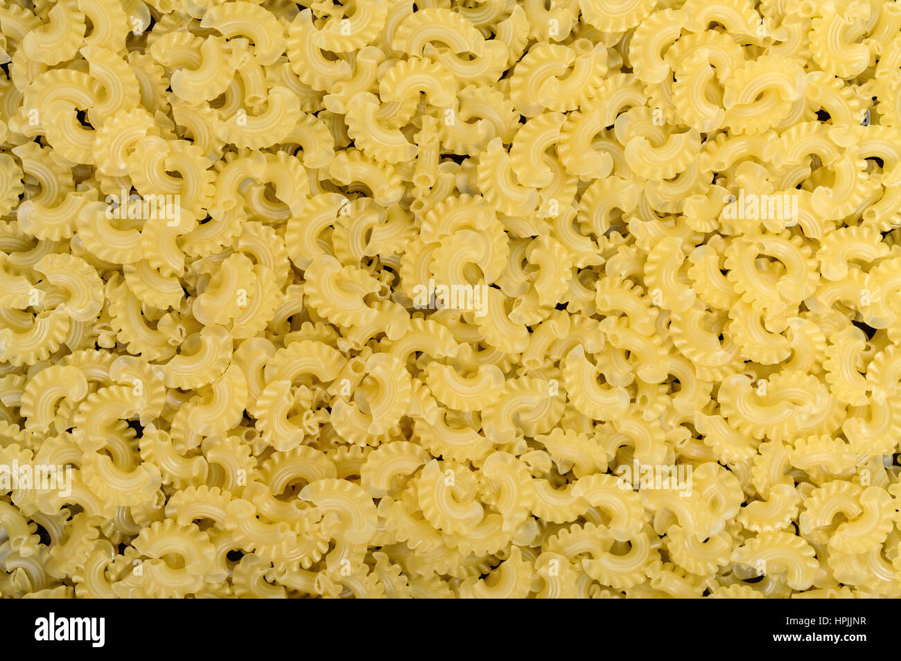 Raw macaroni - pasta Galetti closeup. Background texture Stock Photo ...