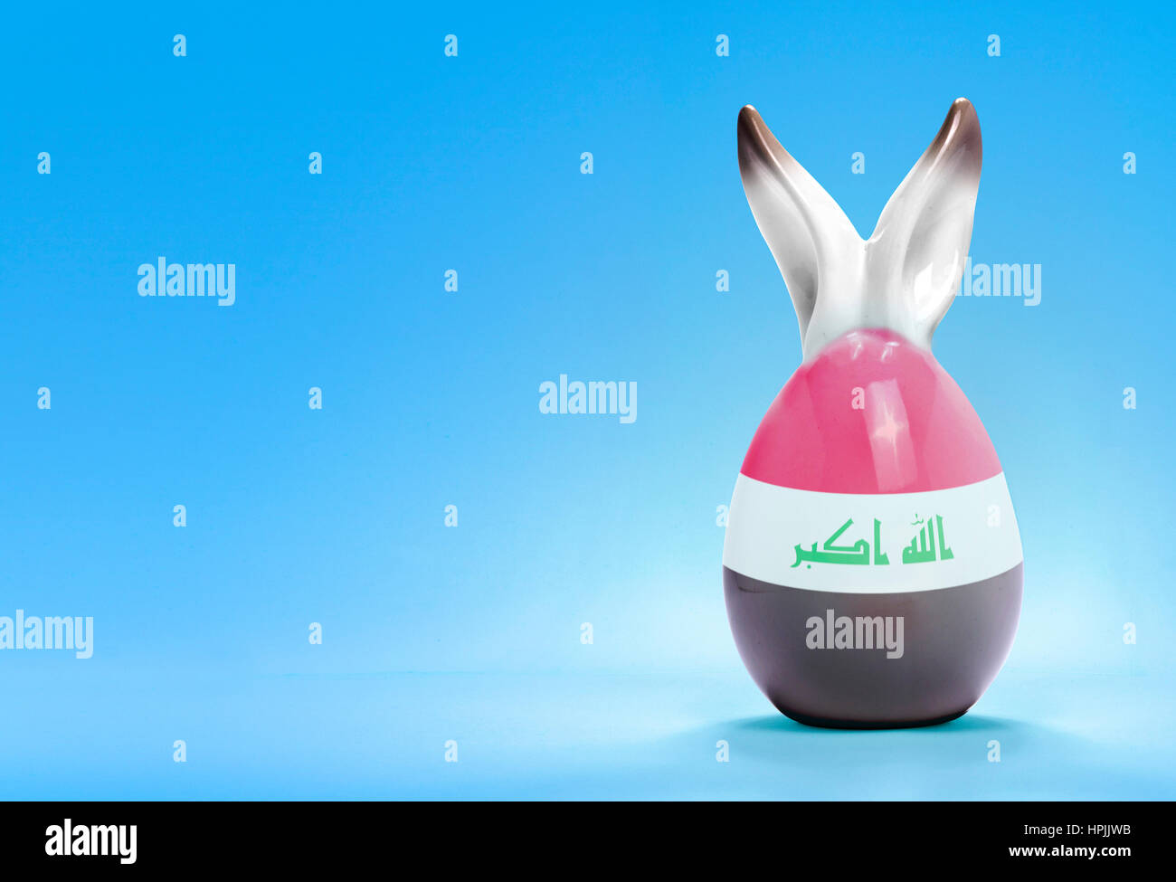 Colorful cute ceramic easter egg with rabbit ears and the flag of Iraq ...