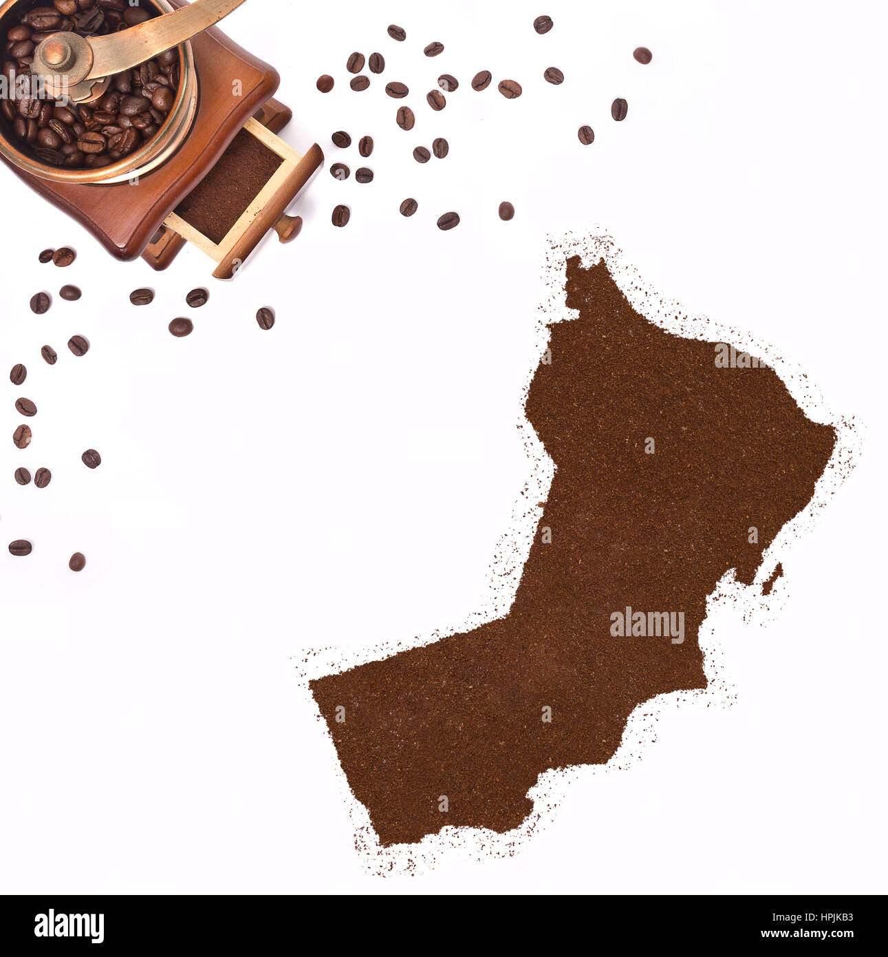 Coffee powder in the shape of Oman and a decorative coffee mill.(series ...