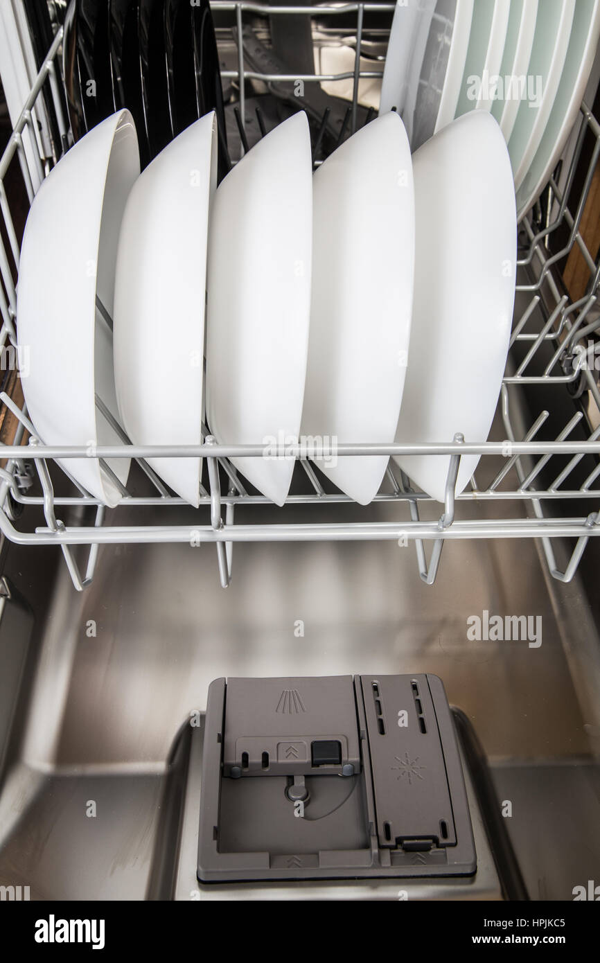 Clean white plates in a modern dishwasher machine Stock Photo - Alamy