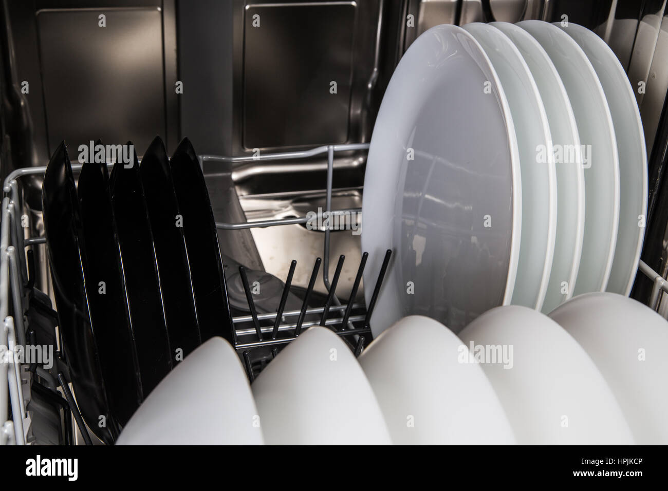 Clean plates in a modern dishwasher machine Stock Photo - Alamy