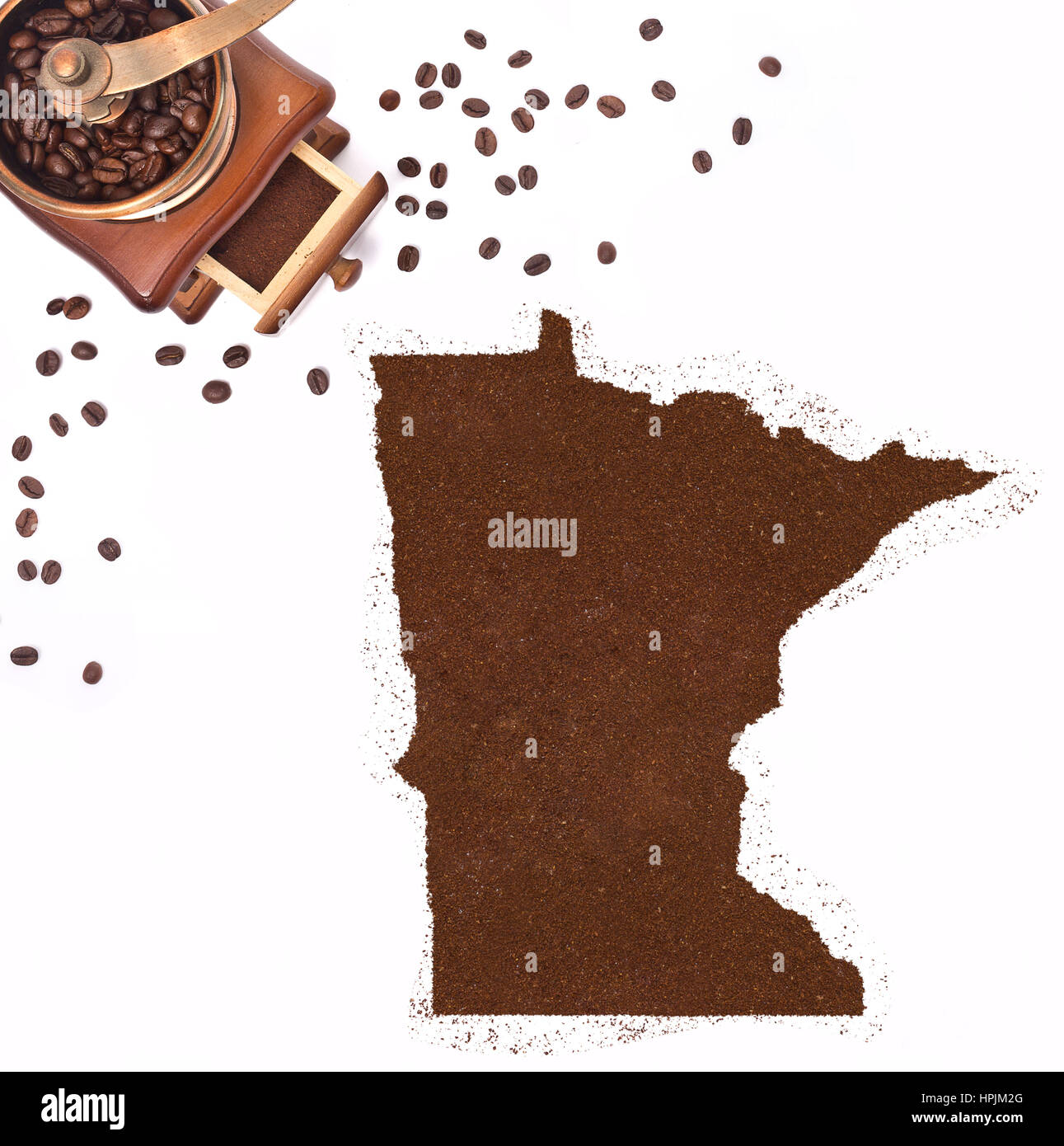 Coffee powder in the shape of Minnesota and a decorative coffee mill ...
