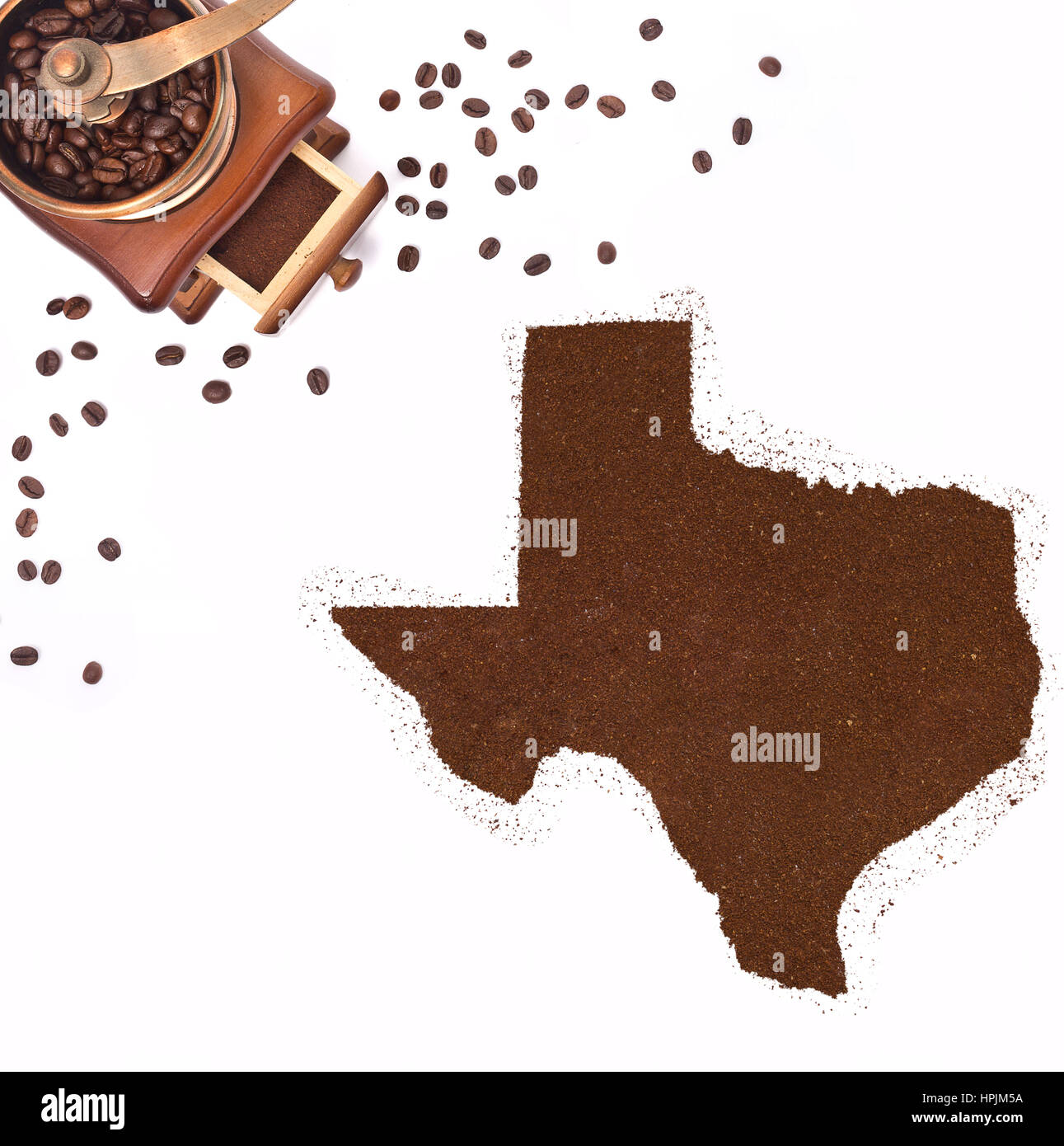 Coffee powder in the shape of Texas and a decorative coffee mill ...
