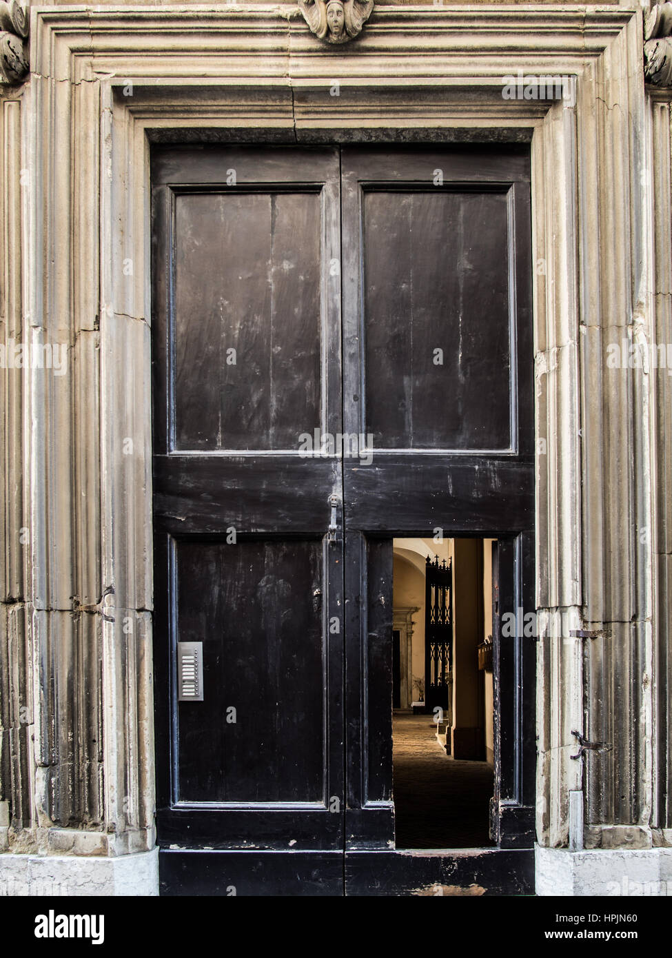 Ancient wood oak door with marble frame portal on old brick wall ...