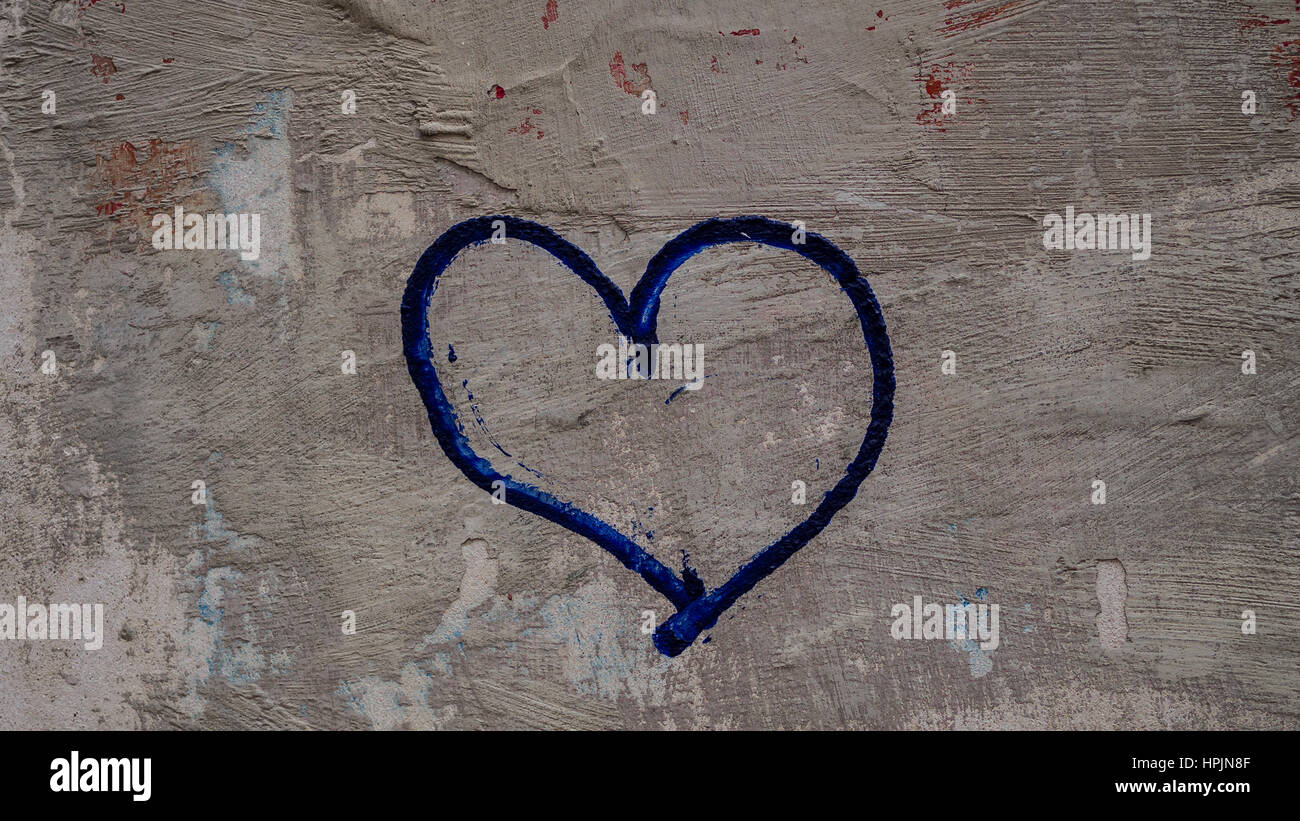 Urban blue heart painted on wall, symbol Stock Photo - Alamy