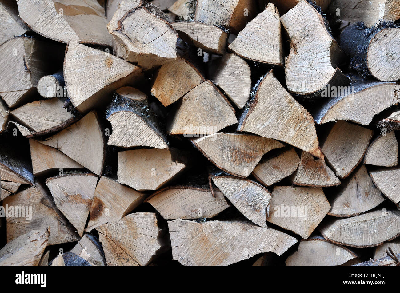 Natural wooden closeup background - pile of stacked triangle firewood ...