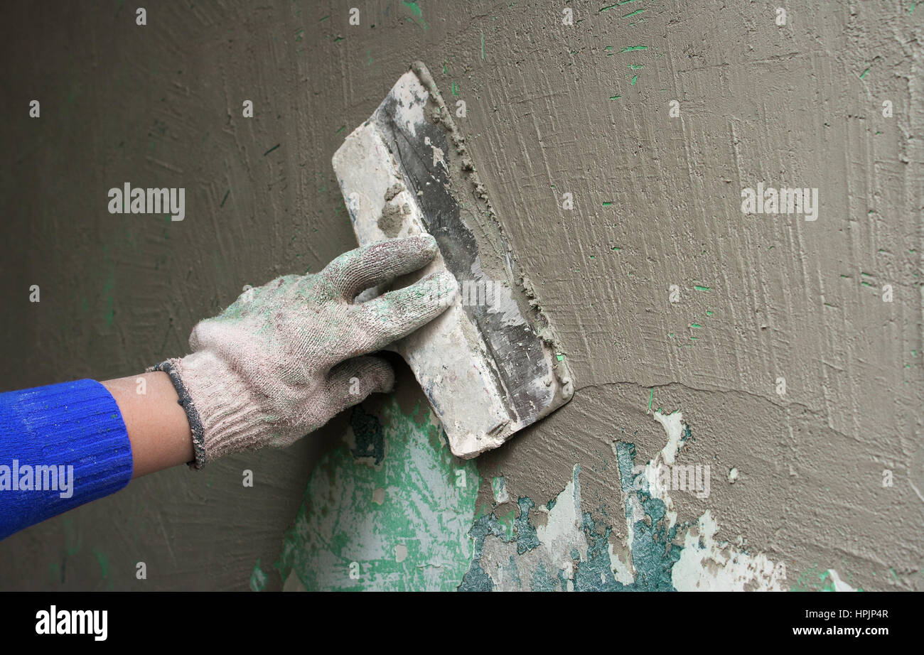 female's hand with a trowel plaster wall outdoor closeup Stock Photo ...