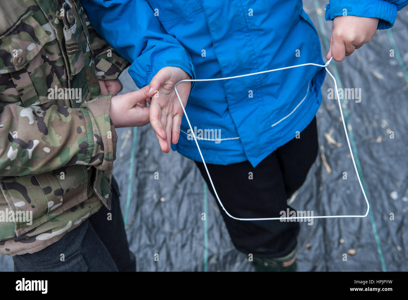 Primary school kids making a pond dipping net out of a womans stocking ...