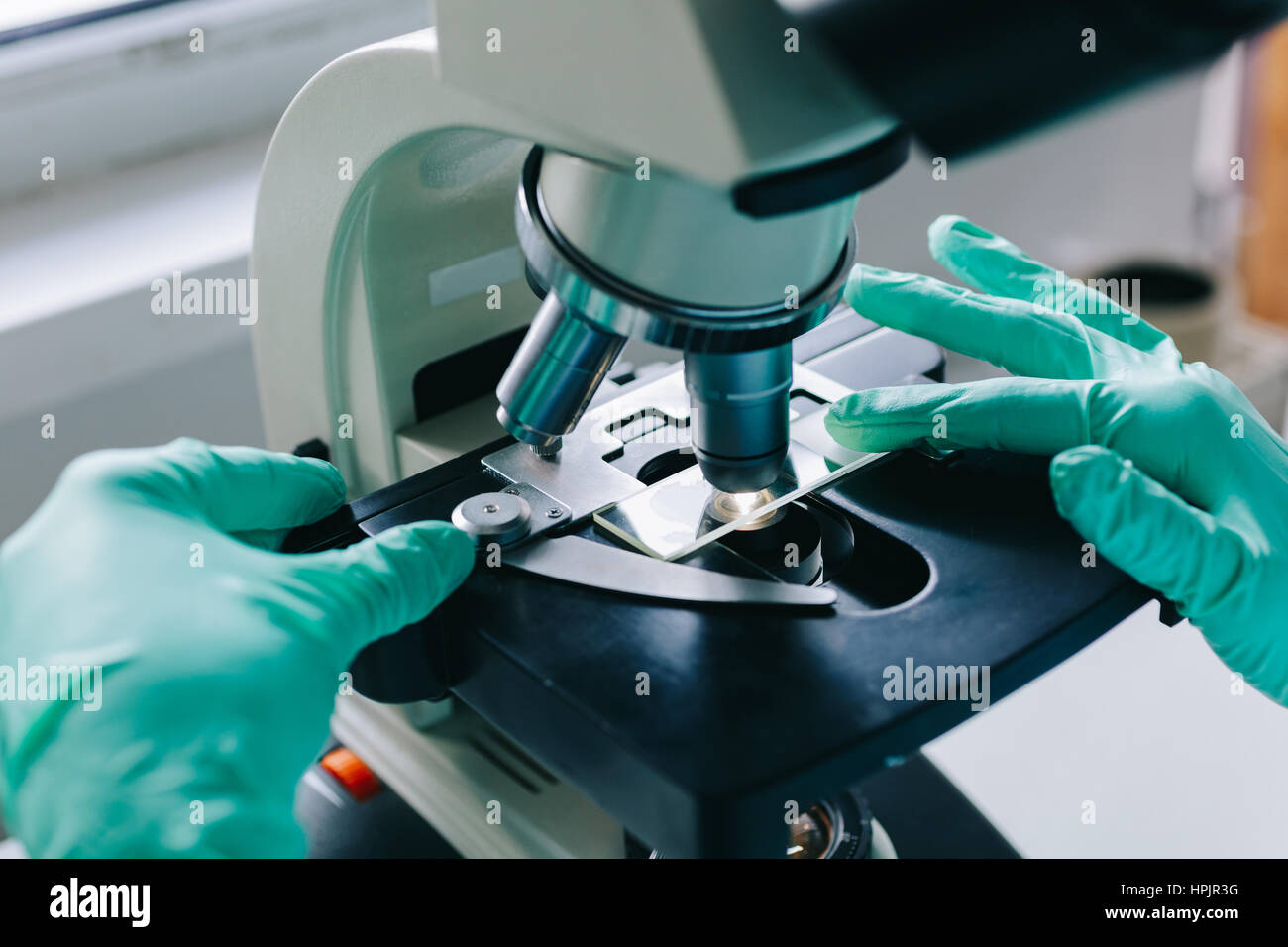 Close up view of small glass under microscope Stock Photo - Alamy